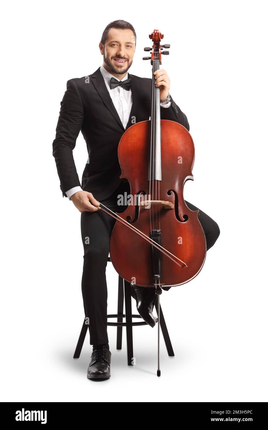 Male musician in a black suit and bow-tie sitting on a chair with a ...