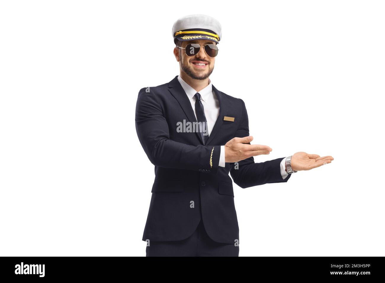 Pilot in a uniform showing direction with hands isolated on white ...