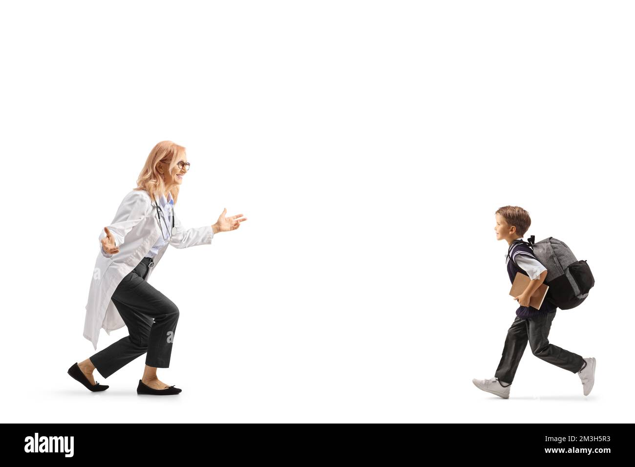 Schoolboy with a book running to hug a female doctor isolated on white ...