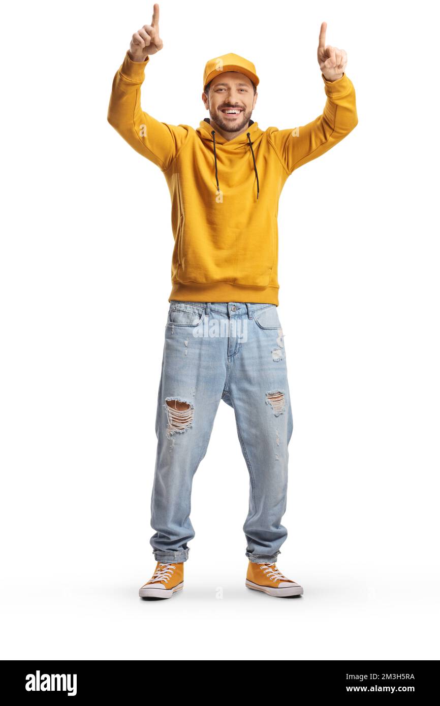 Young man in a hoodie and cap pointing up isolated on white background ...