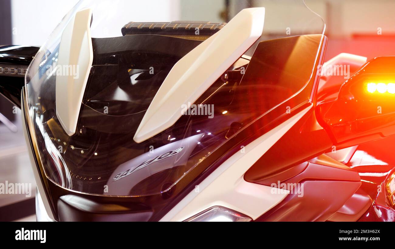Big moto. Media.A bright white motorcycle that is highlighted in red ...