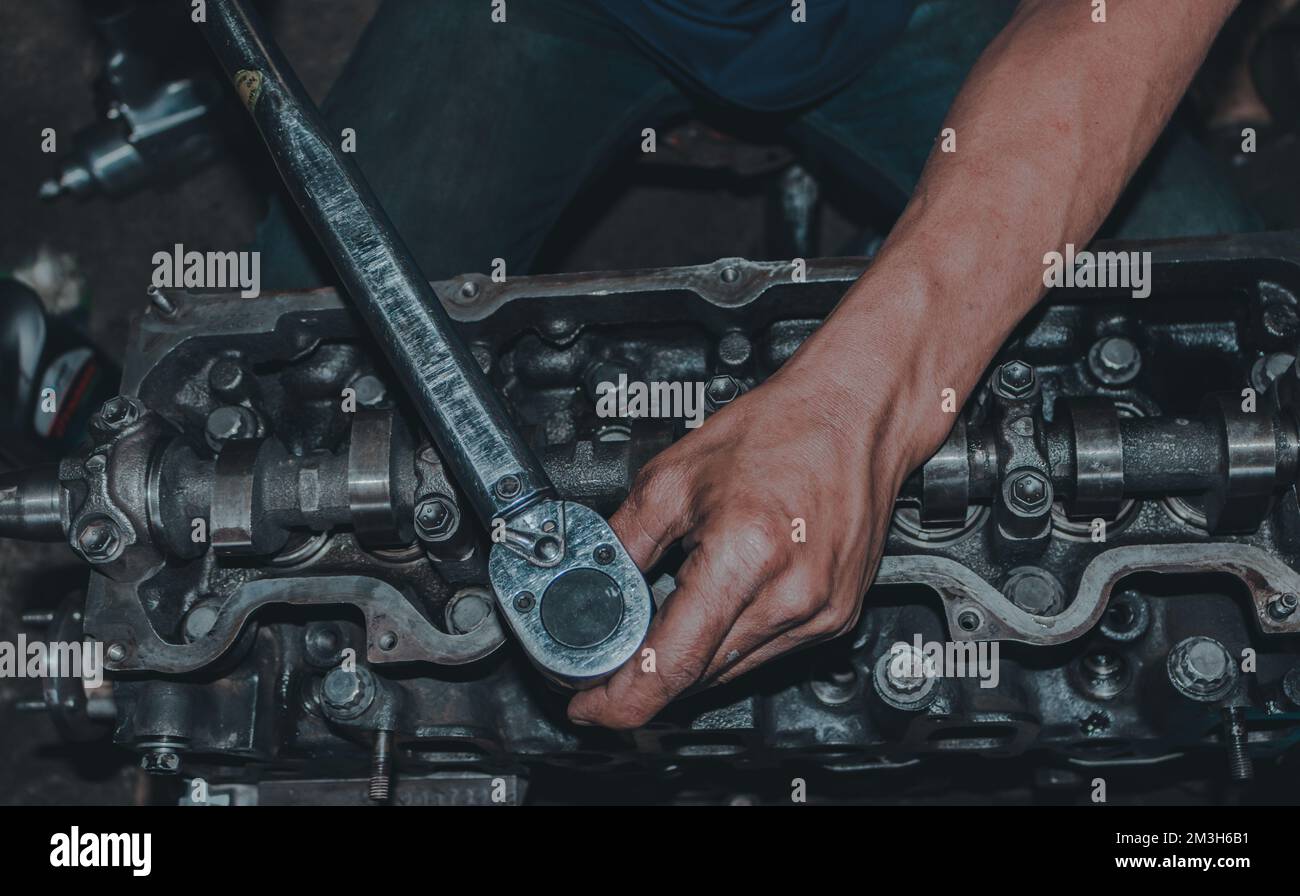 The Caucasian hands of a mechanic is checking the engine Stock Photo ...