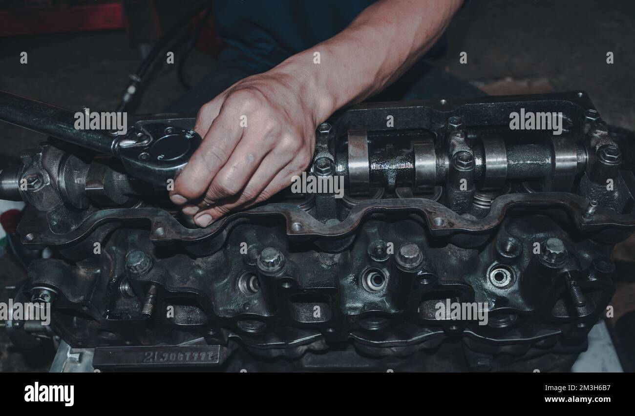 The Caucasian hands of a mechanic is checking the engine Stock Photo ...