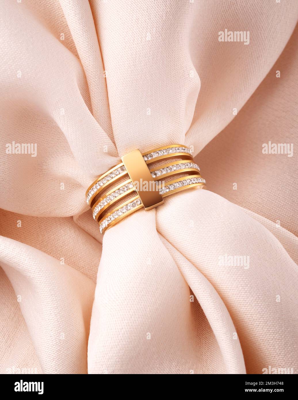 Beautiful gold ring on a beautiful textile background, concept or ...