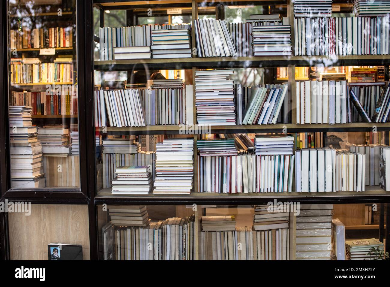 A view of a bookstore with lots of shelves displaying various types of ... A view of a bookstore with lots of shelves displaying various types of ...