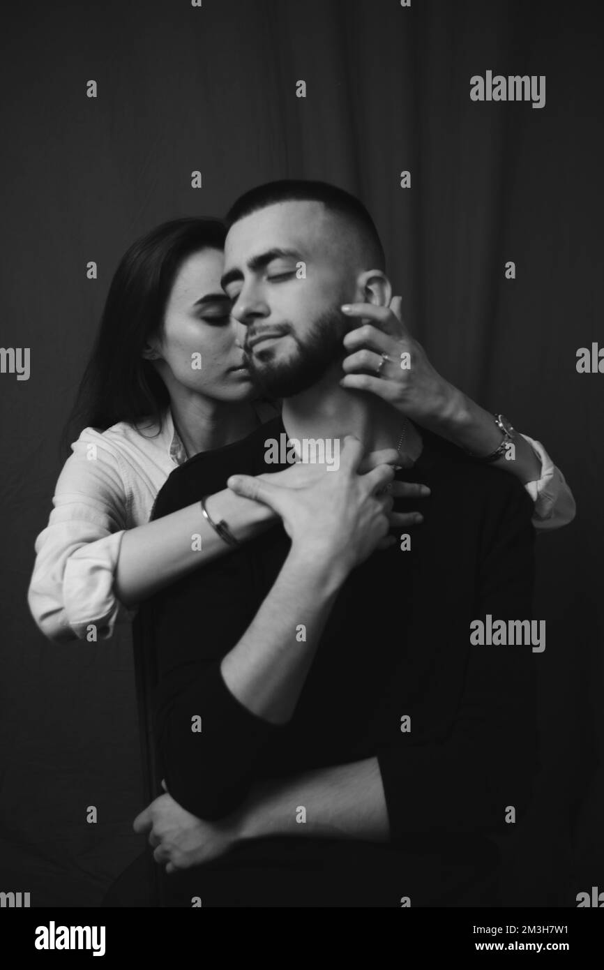 the girl hugs her boyfriend from behind Stock Photo - Alamy