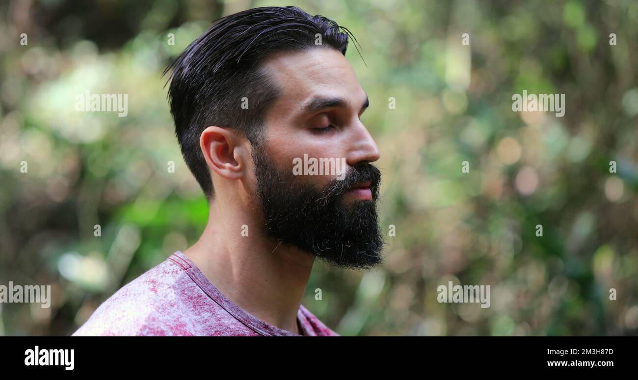 Handsome man meditating outside in nature. Yogi person in meditation ...