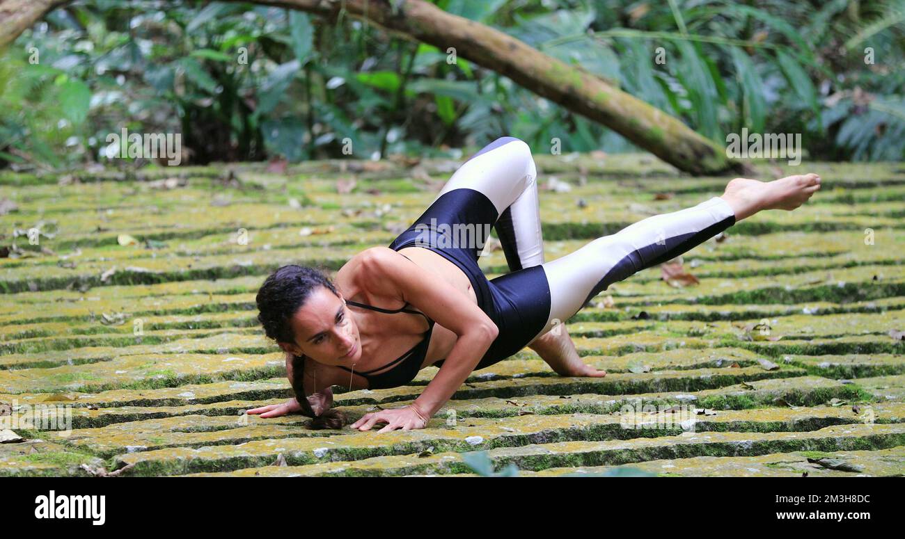 Athletic fit yogi woman training difficult yoga pose outdoors Stock ...