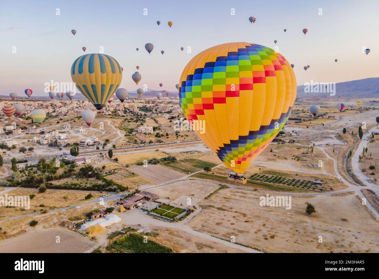 Colorful hot air balloons flying over at fairy chimneys valley in ...
