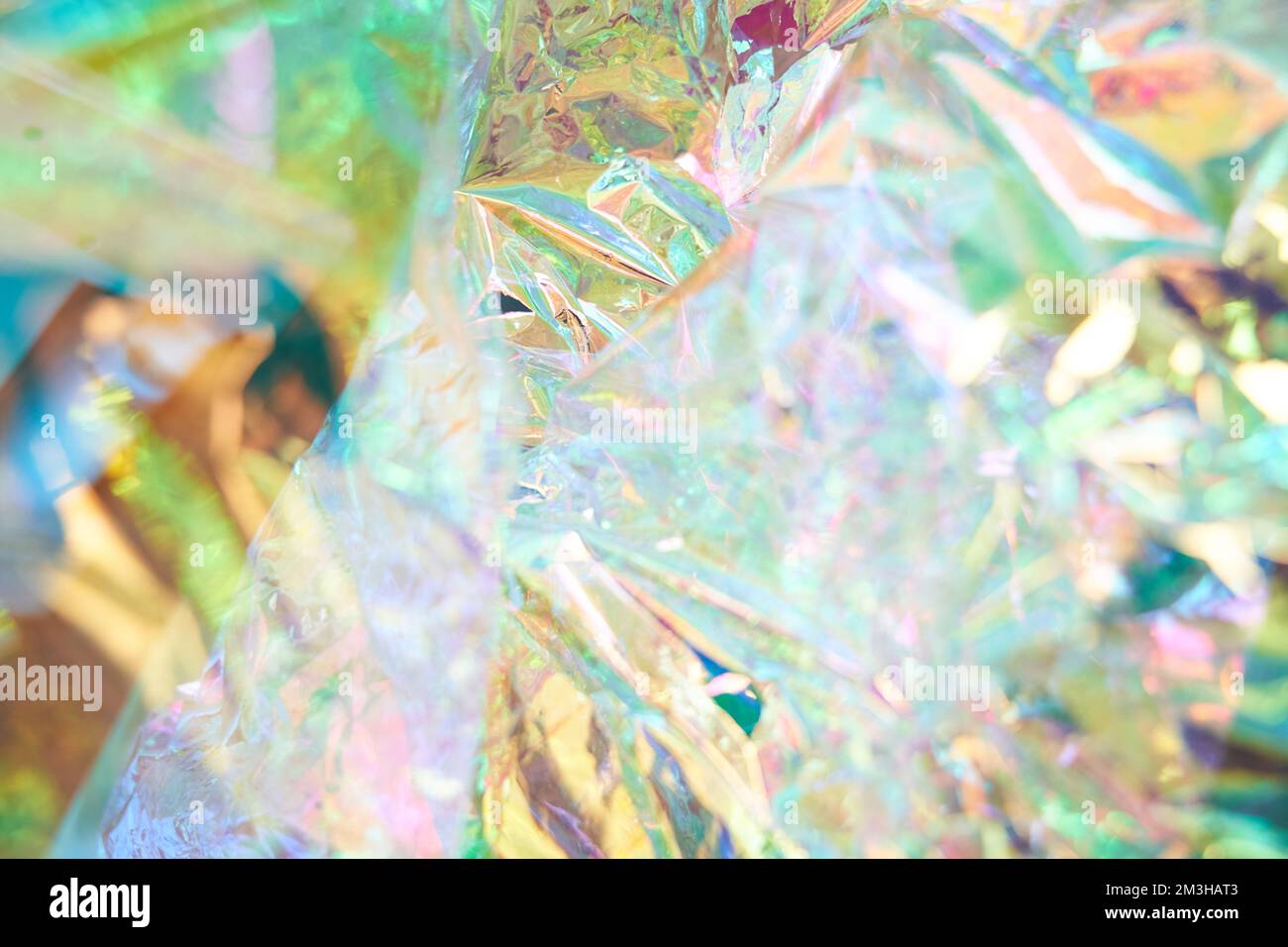 Unfocused holographic colors of mother-of-pearl foil. Crumpled ...