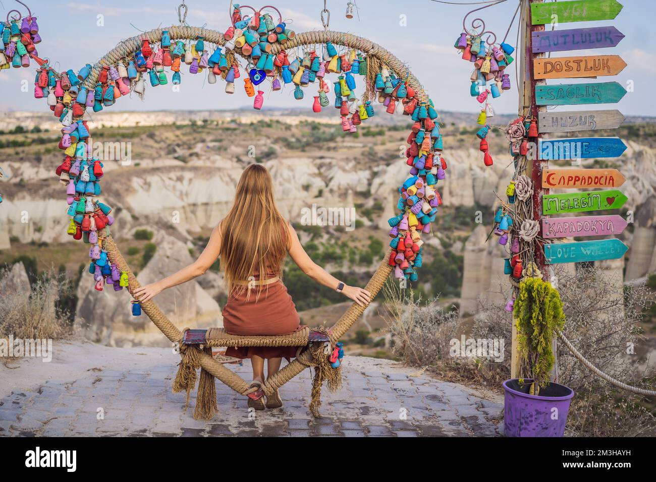 Young woman exploring valley with rock formations and fairy caves near ...