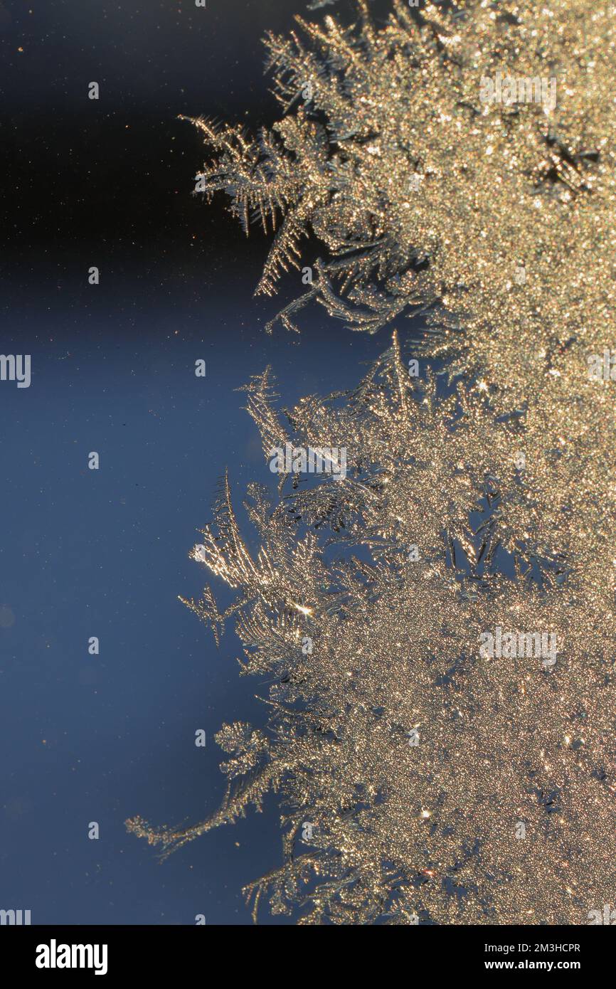 Macro image of ice crystals from frost formed on a window with dark ...