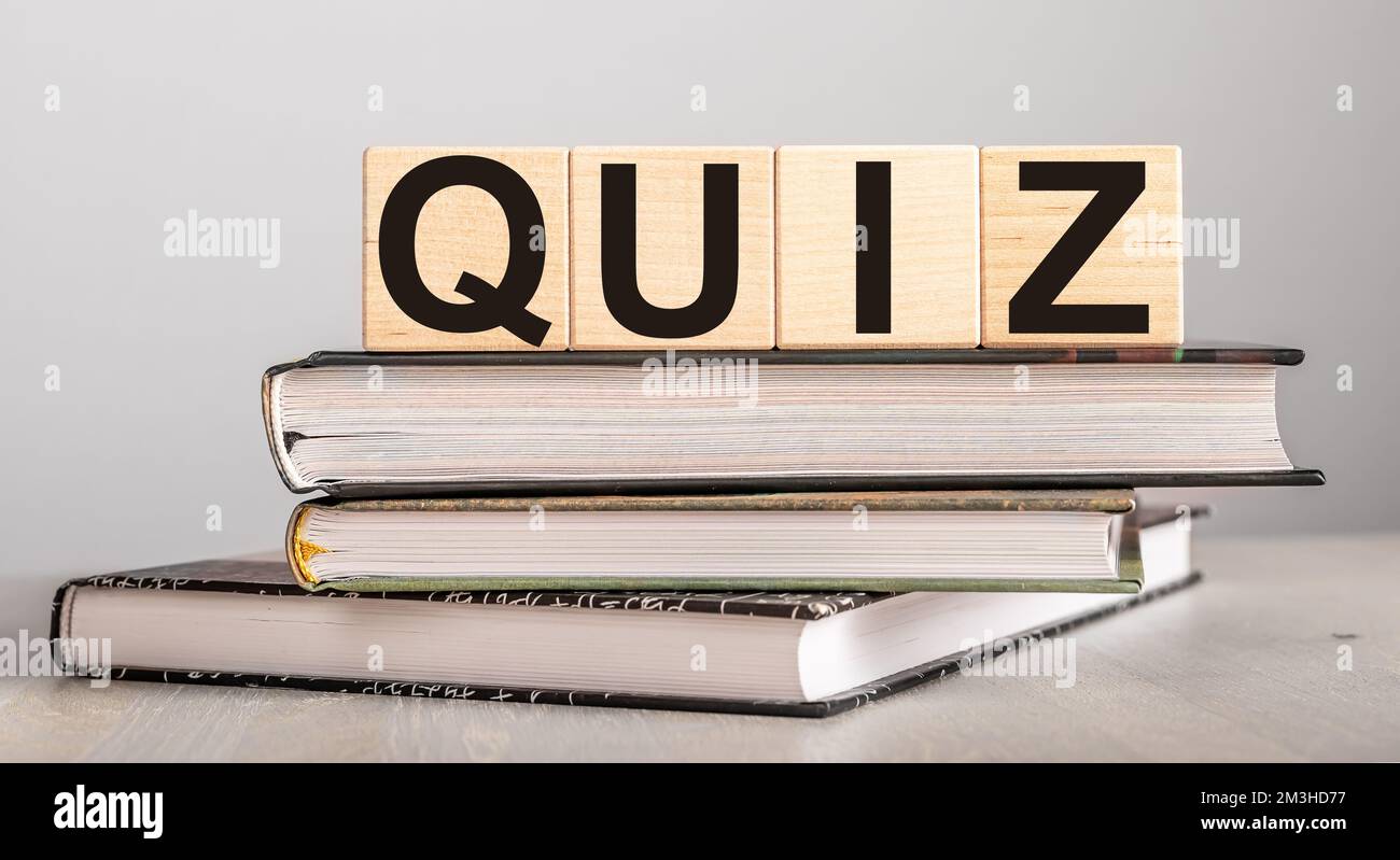 Quiz word on wood blocks and books for education. Quizz, test for ...