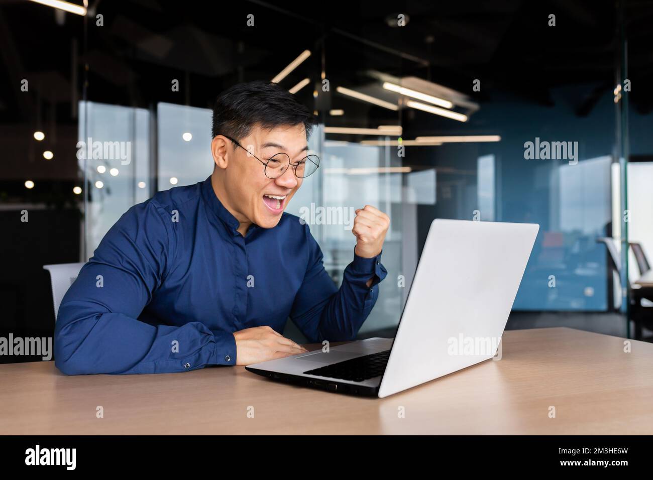 Successful asian man celebrating victory and success received news of ...