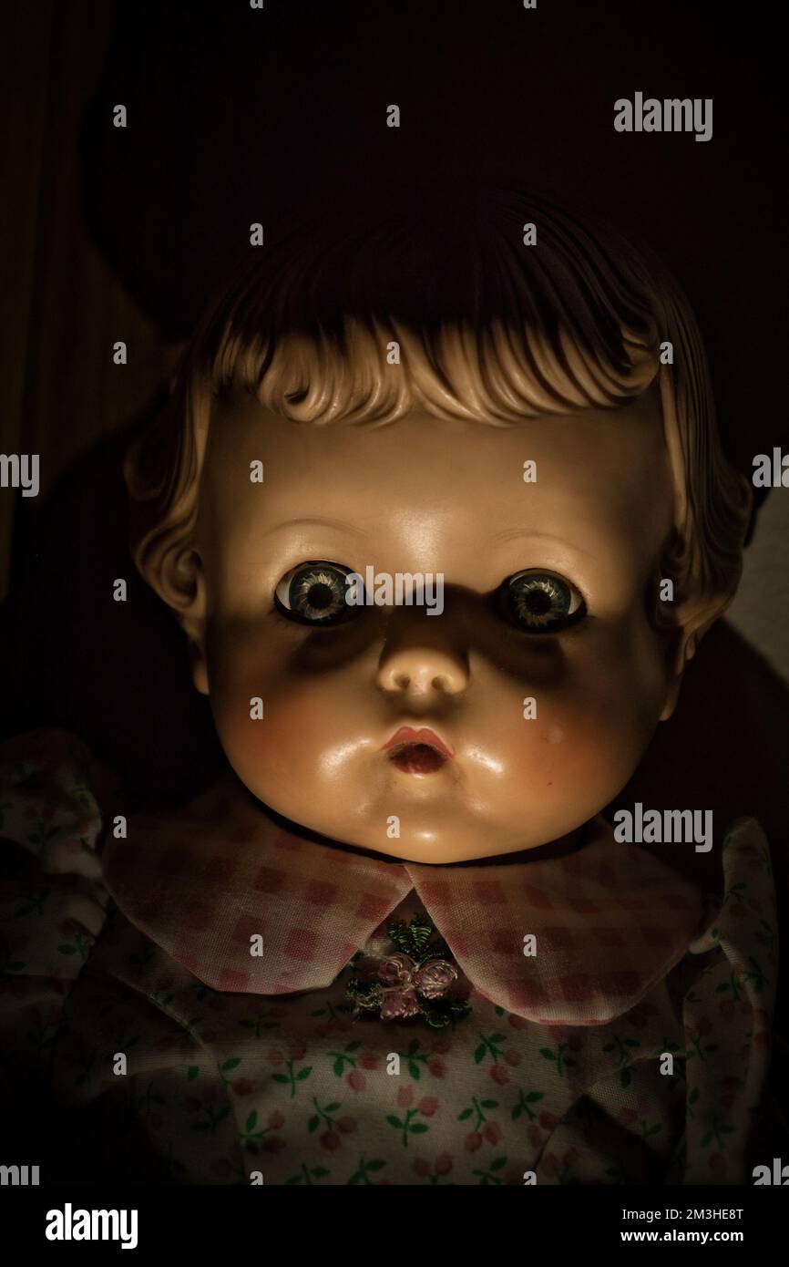 Spooky doll in dark room with shadows across the face Stock Photo - Alamy