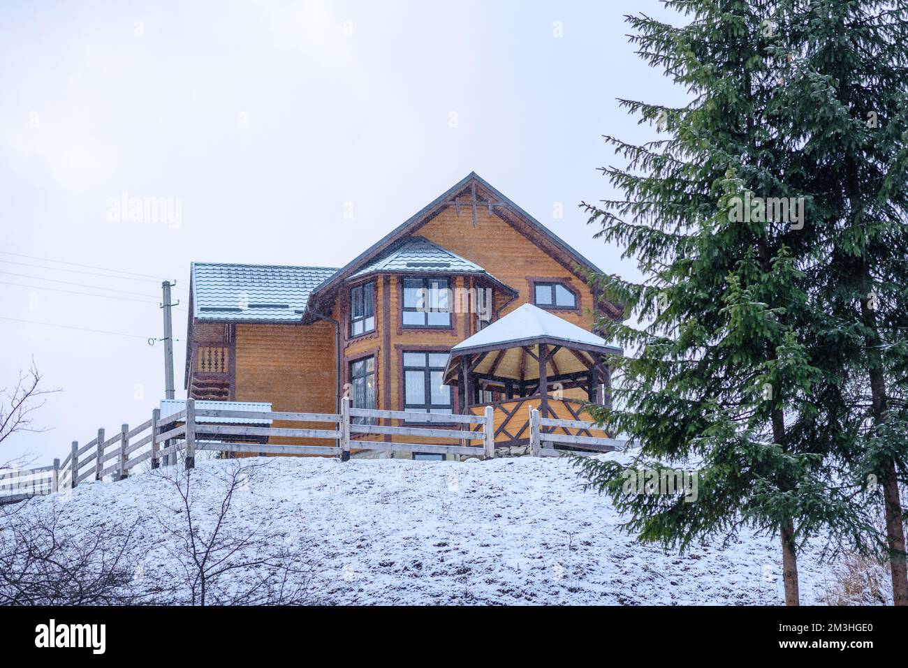 Wooden house in a beautiful winter green coniferous forest on the ...