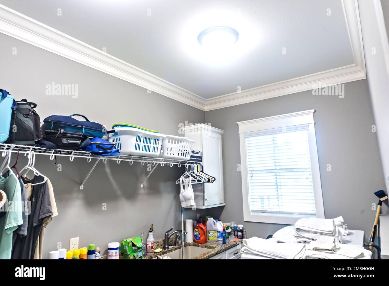 A messy laundry room filled with cleaning products Stock Photo - Alamy