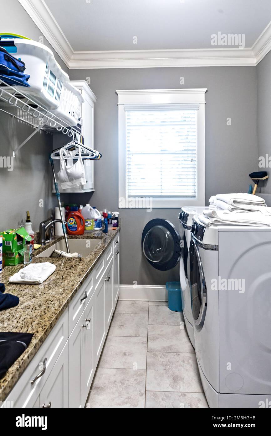 A messy laundry room filled with cleaning products Stock Photo - Alamy