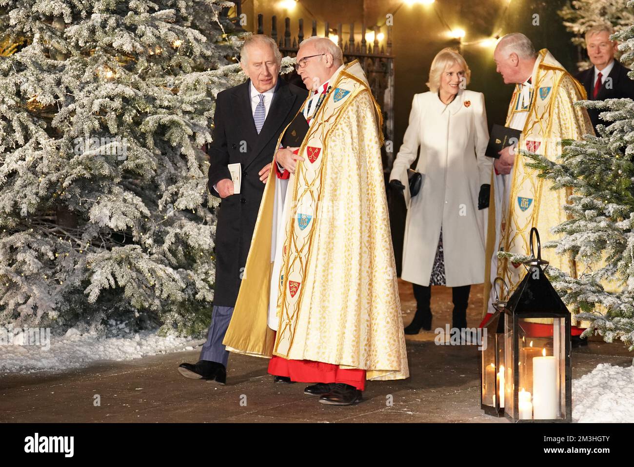 King Charles III talking to Dean of Westminster David Hoyle followed by ...