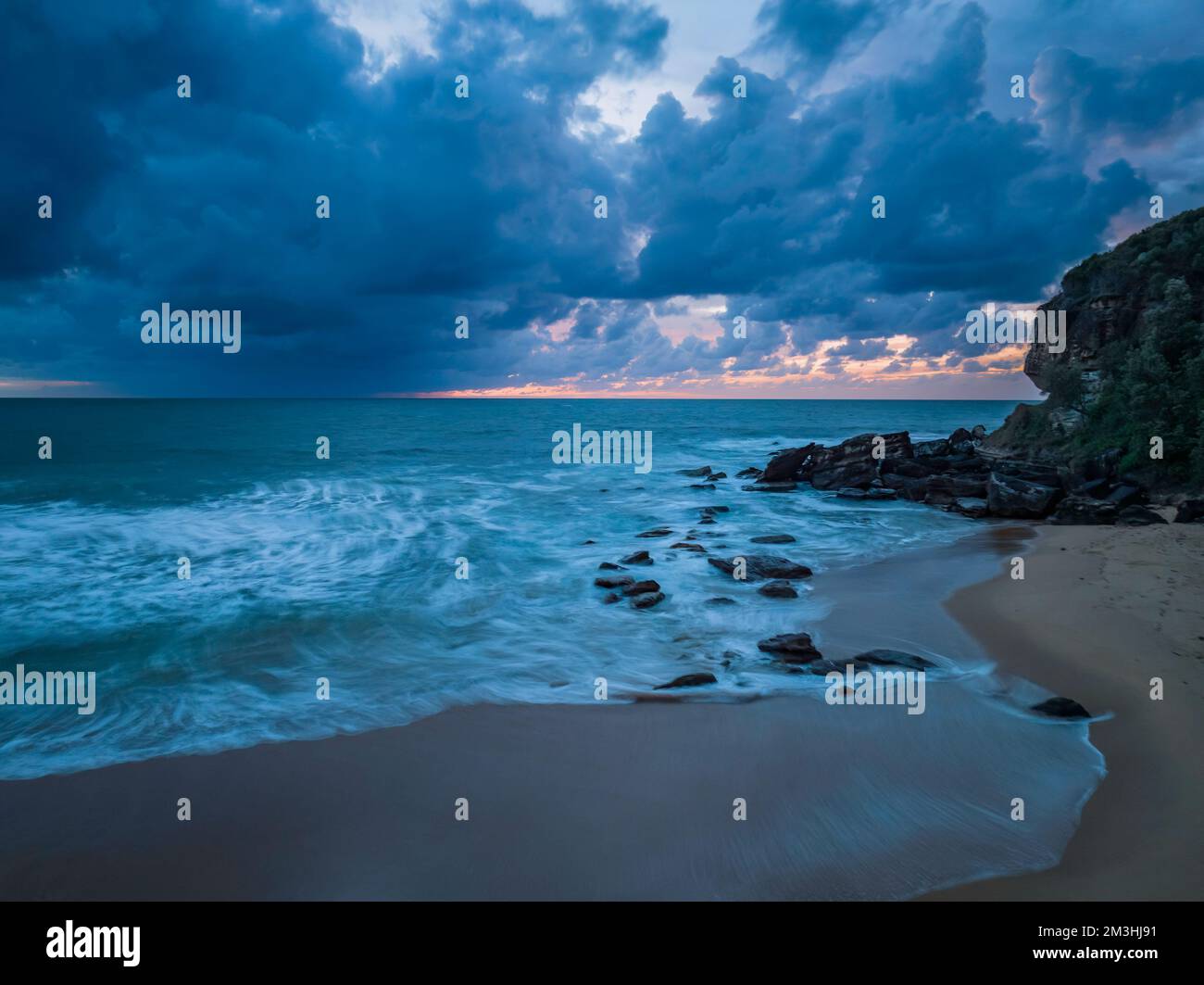 Aerial sunrise seascape with rain clouds at Killcare Beach on the ...