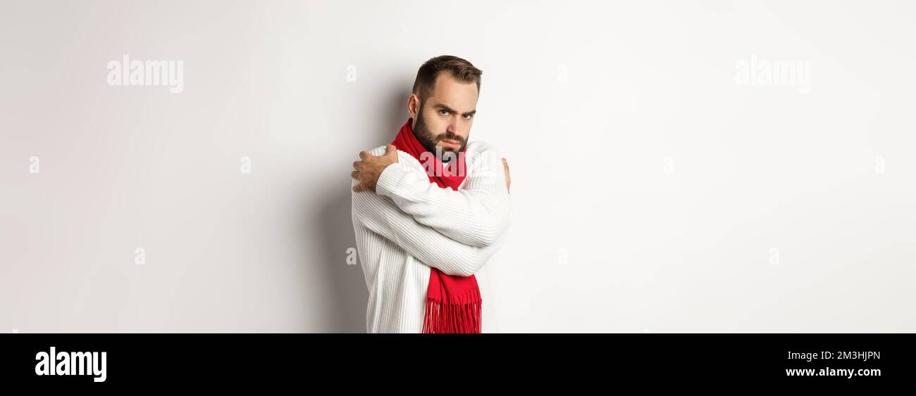 Offended guy embracing himself and looking displeased at camera ...