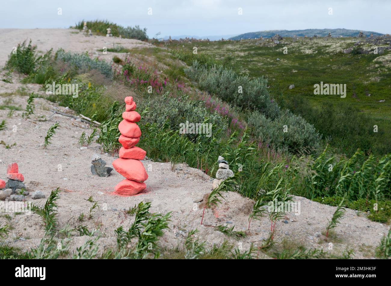 Orange zen pyramid of stones on the side of a mountain road Stock Photo ...