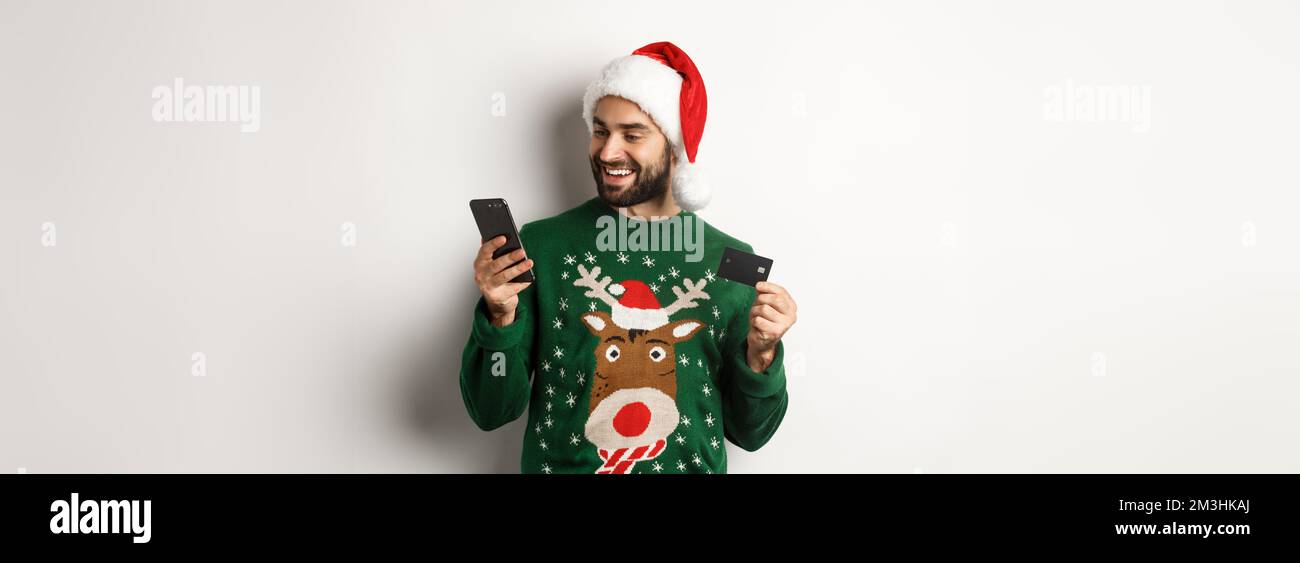 New Year, online shopping and christmas concept. Happy bearded man ...