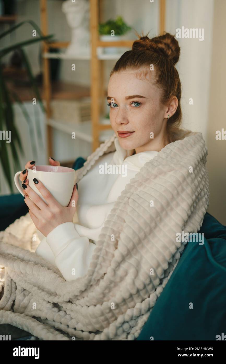 Happy caucasian woman with red hair enjoying quiet time at home ...