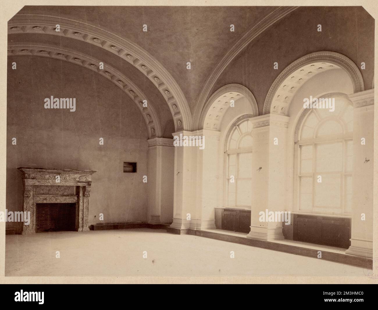 Music library showing fireplace and two of 3 arched windows, looking ...