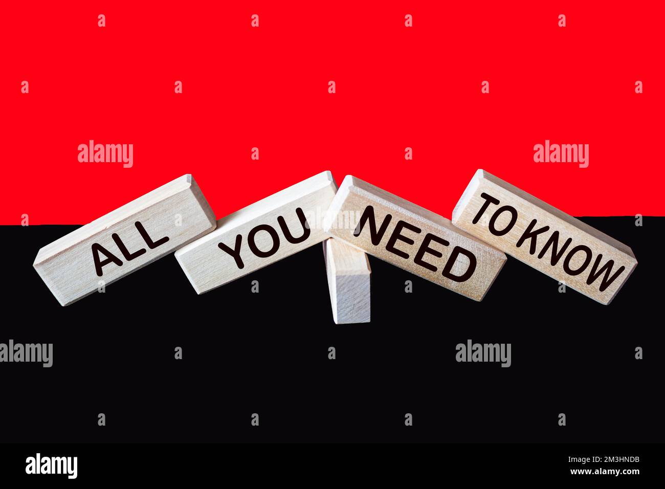 Wooden blocks with the words Everything you need to know on a black and red background. Business ...