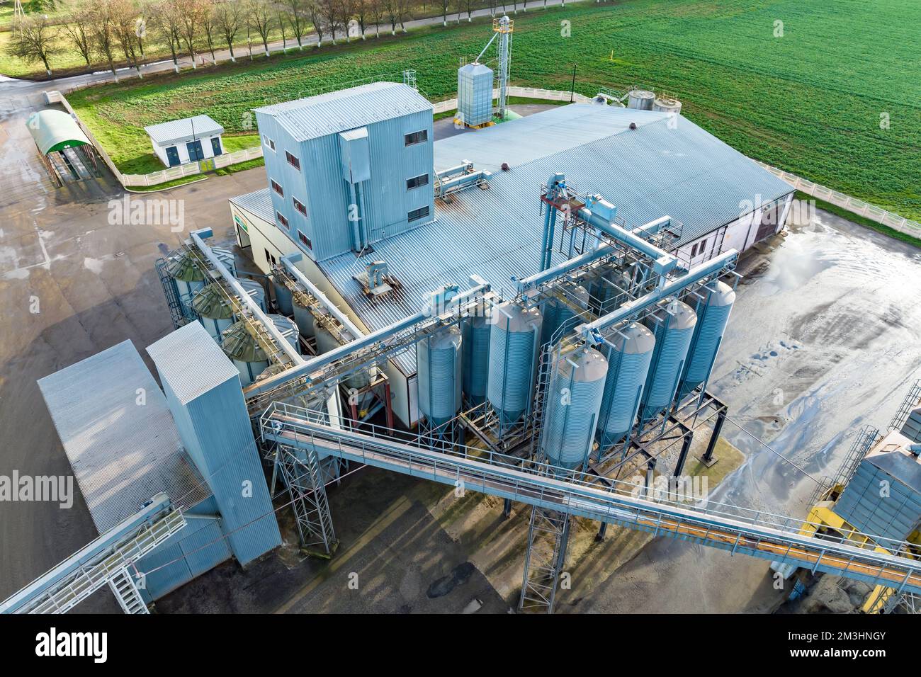 aerial view of huge agro-industrial complex with silos and grain drying ...