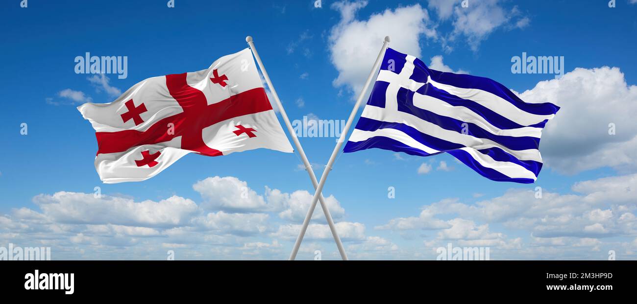 two crossed flags Greece and Georgia waving in wind at cloudy sky ...