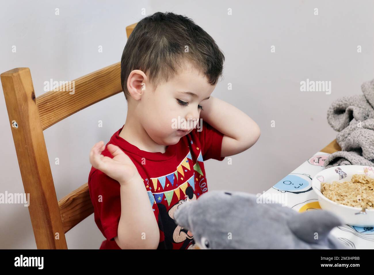 impatient young boy waiting for his oatmeal to cool down Stock Photo ...