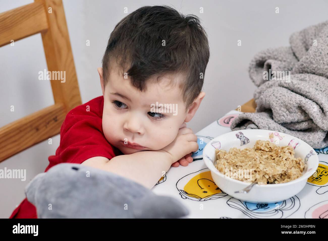impatient young boy waiting for his oatmeal to cool down Stock Photo ...