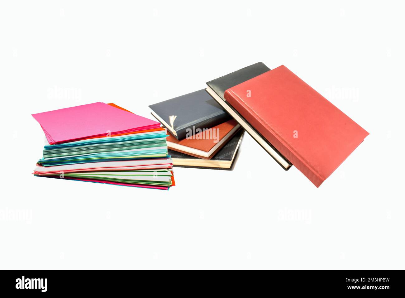 A pile of colored notebooks and sheets isolated on white background Stock Photo - Alamy