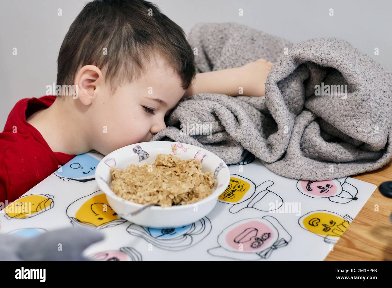 impatient young boy waiting for his oatmeal to cool down Stock Photo ...