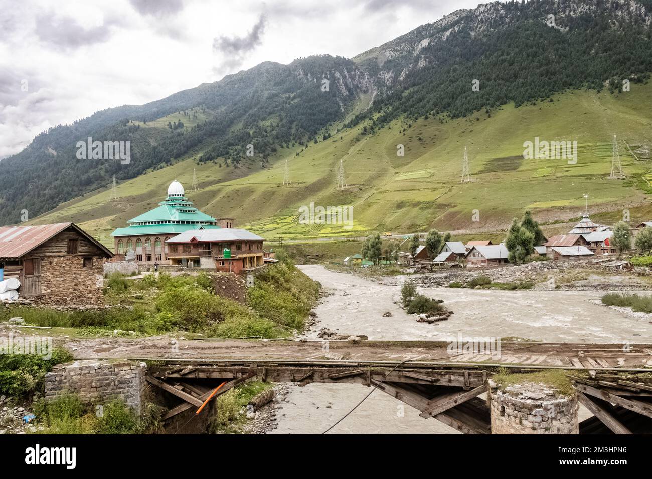 A beautiful mountain scenery with houses and river in a valley on the ...