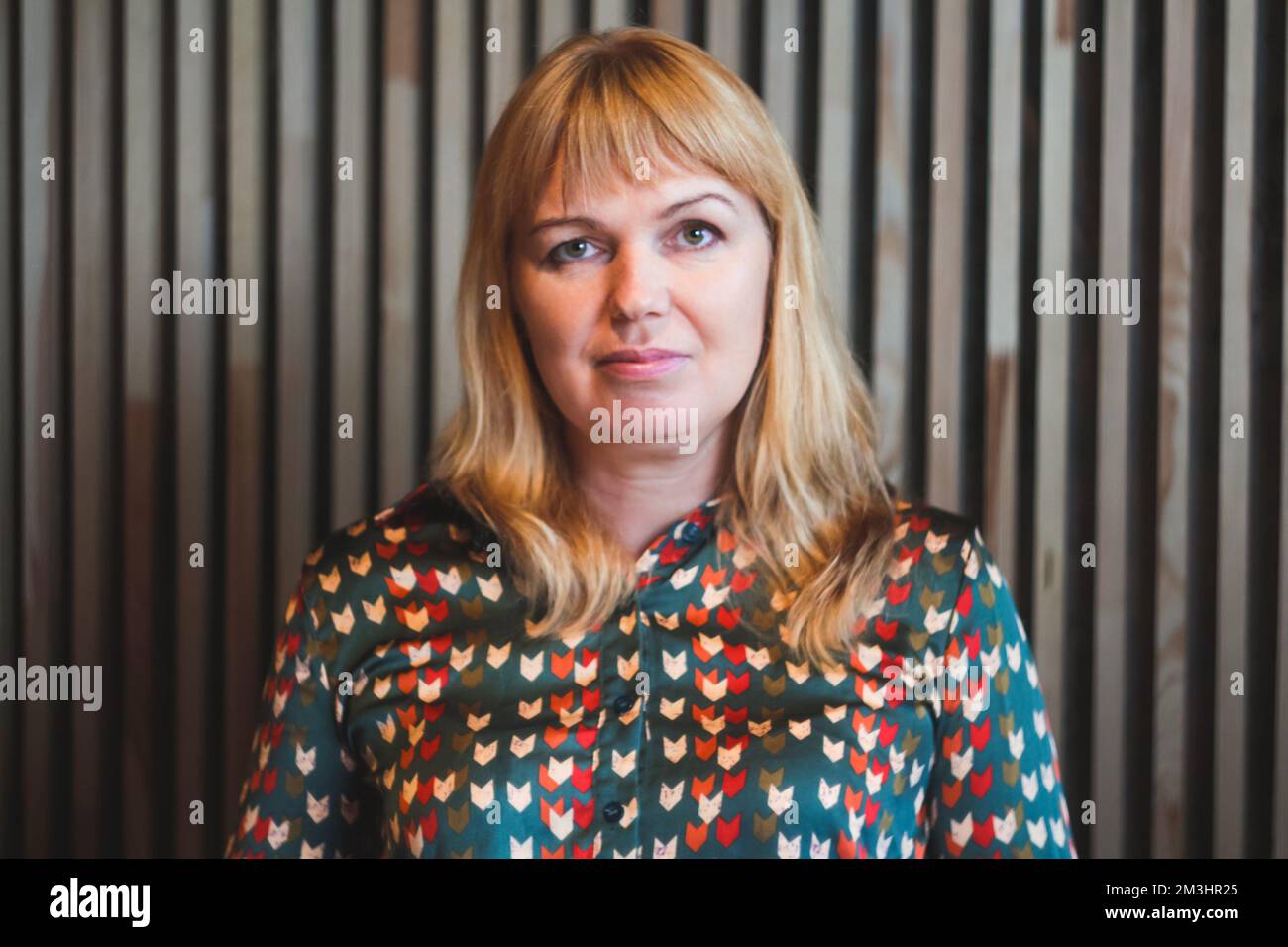 Defocus blonde young woman portrait indoor. Wooden lines on the ...