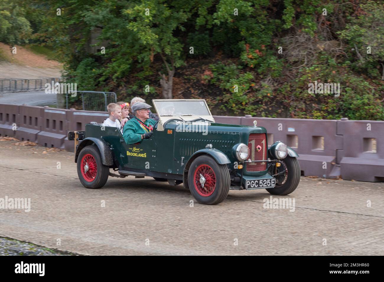 A vintage MG car driving around the historic Brooklands banked track at ...