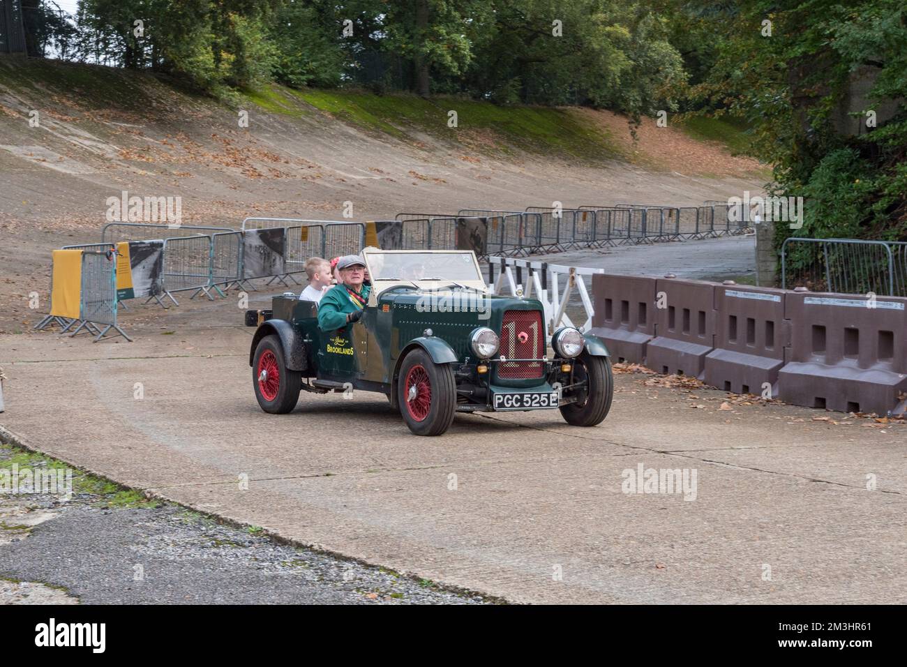 A vintage MG car driving around the historic Brooklands banked track at ...