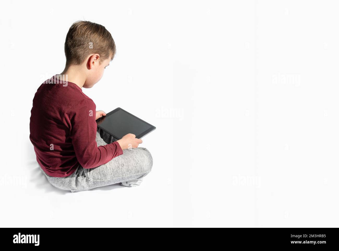 boy playing tablet. white background Stock Photo - Alamy
