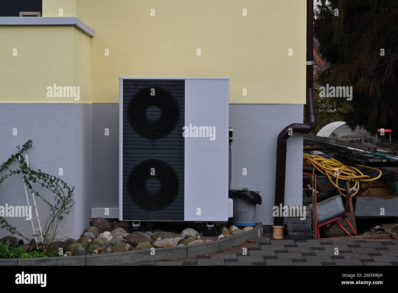 Dark grey colour air source heat pump installed outside the house ...
