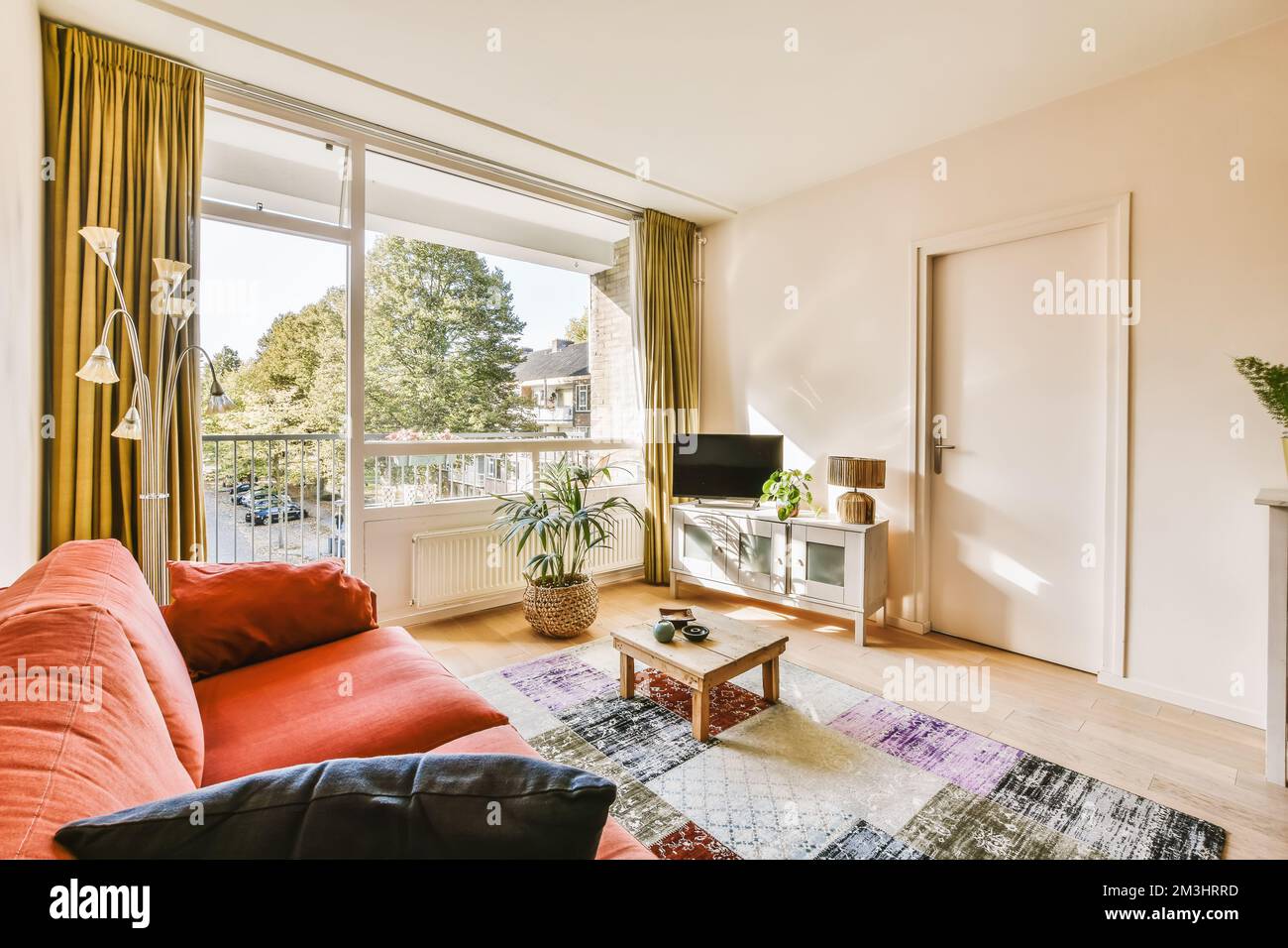 a living room with red couches and a television set on the wall in ...