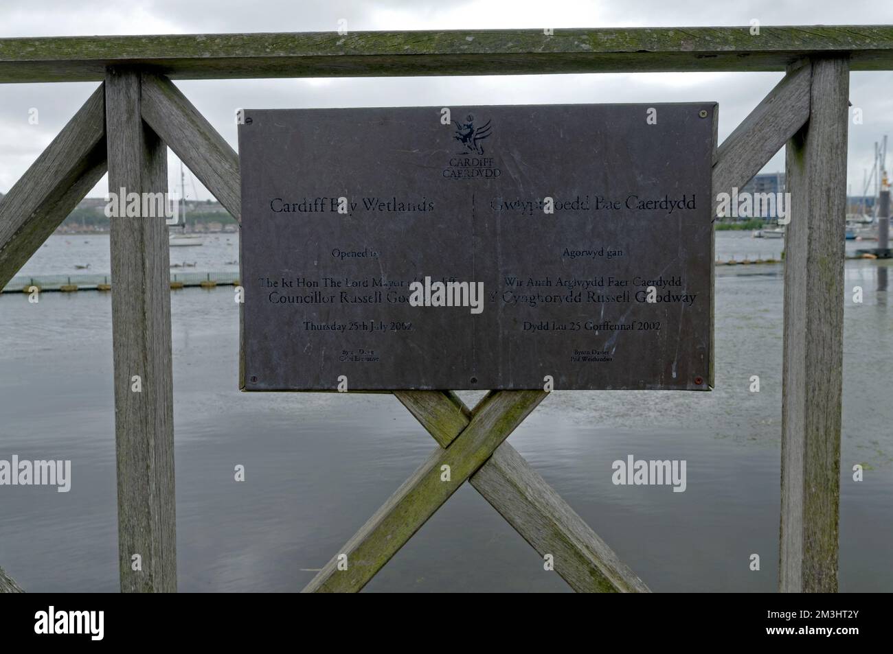Cardiff Bay Wetlands bilingual Welsh / English sign on wooden rail ...