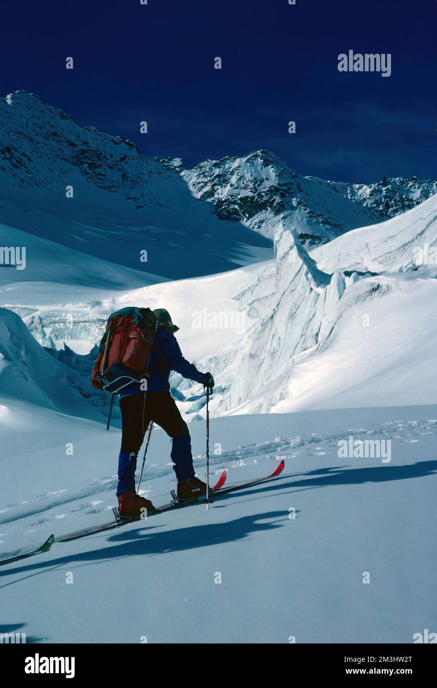 High alpine skiers on the way to the summit in winter Bernese Oberland ...