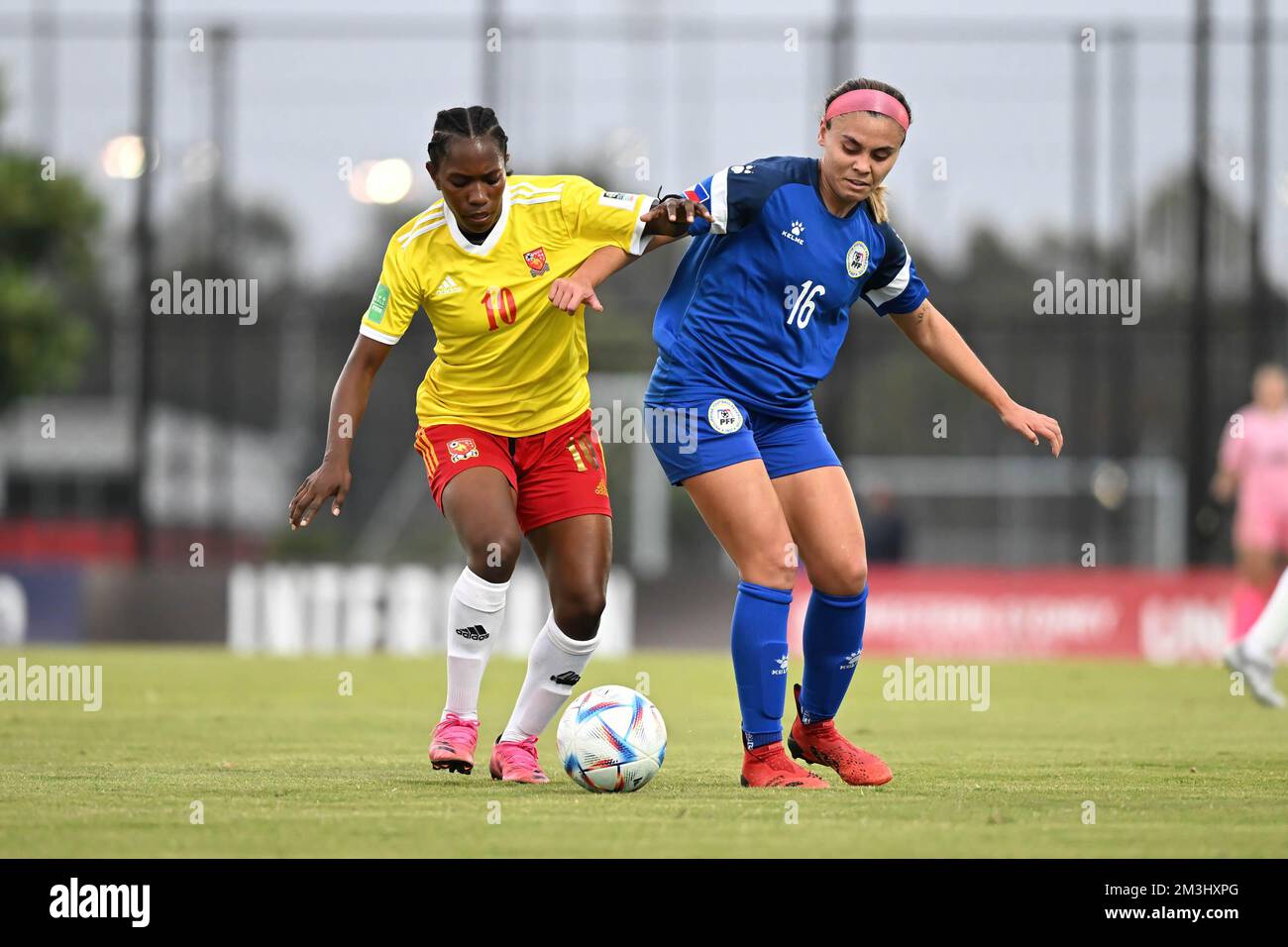 Sofia Nicole Harrison (R) of the Philippine women's soccer and Charlie Yandin (L) of Papua New ...