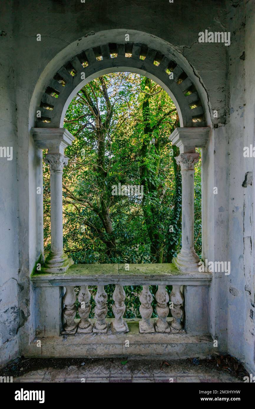 Old overgrown arched balcony in old abandoned mansion Stock Photo - Alamy