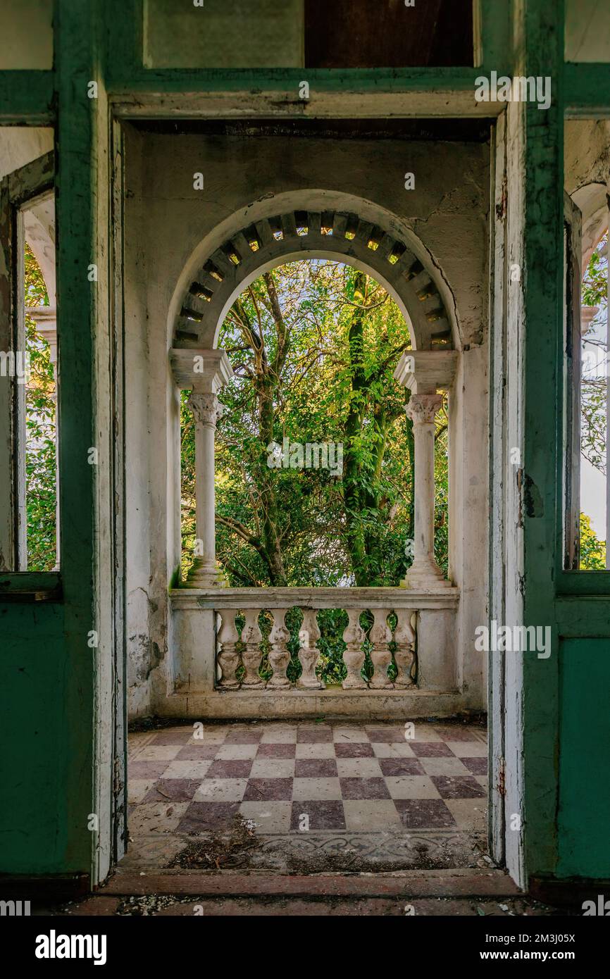 Old overgrown arched balcony in old abandoned mansion Stock Photo - Alamy