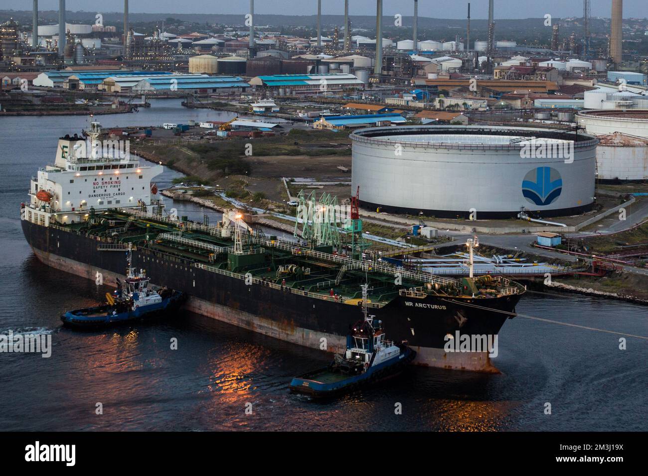 An Oil tanker being docked by two tugboats at the PDVSA oil refinery in ...