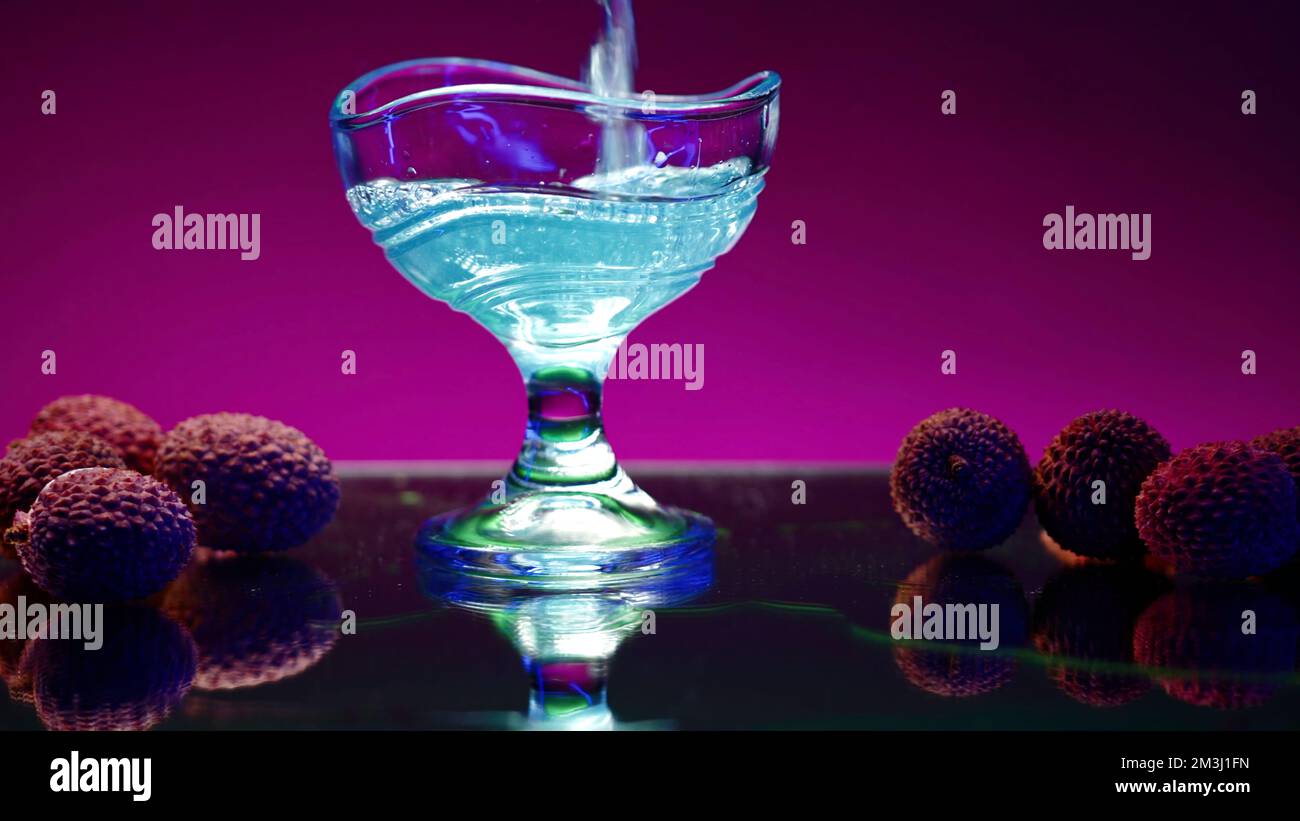 Juicy ripe lychee berries and the blue lagoon cocktail inside a glass ...